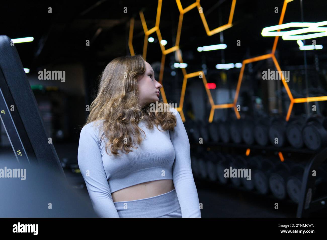 Teenage girl taking a break from boxing in gym. Teen girl tired in the ...