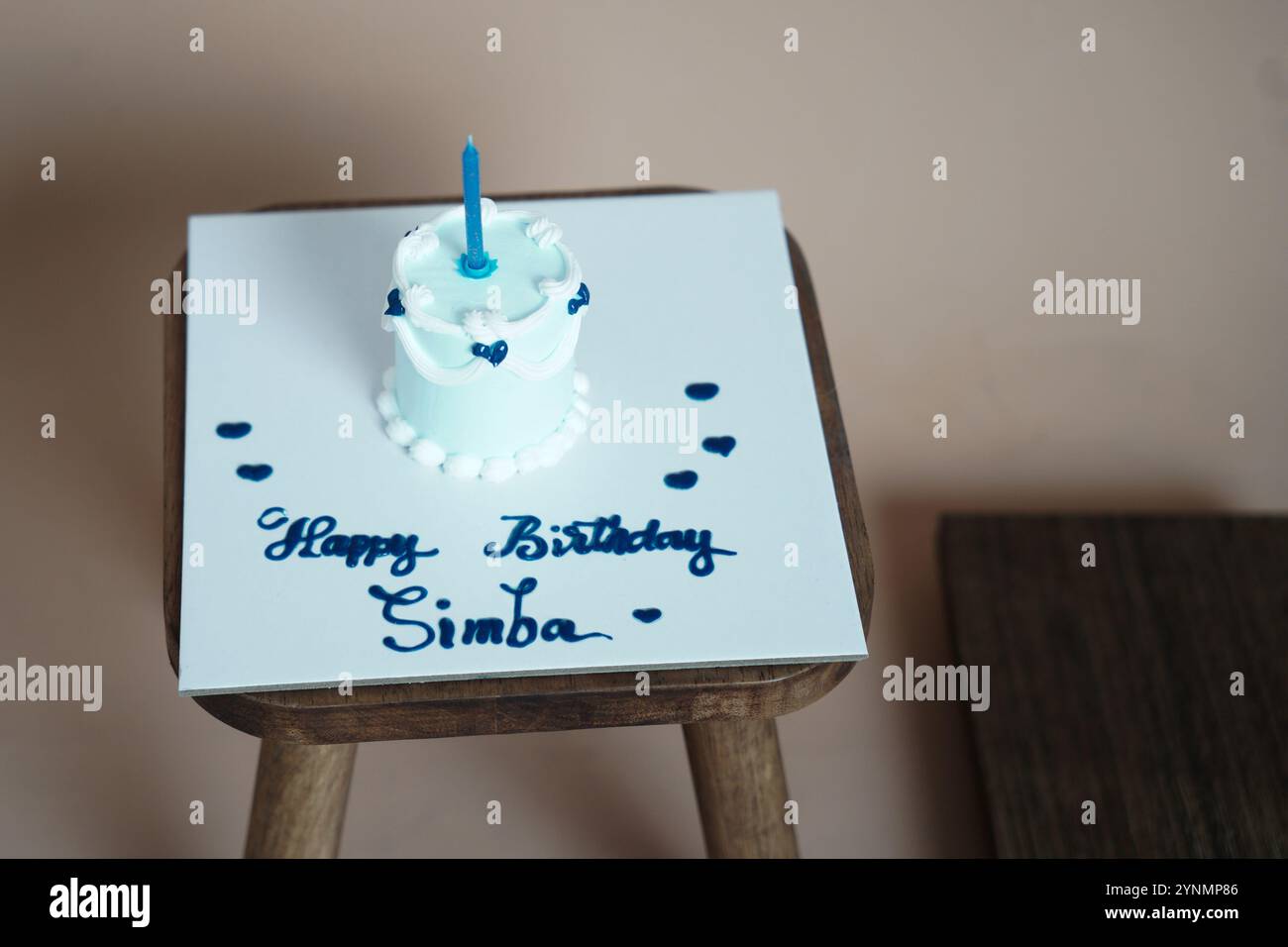 A charming mini birthday cake designed for Simba, adorned with delicate ...