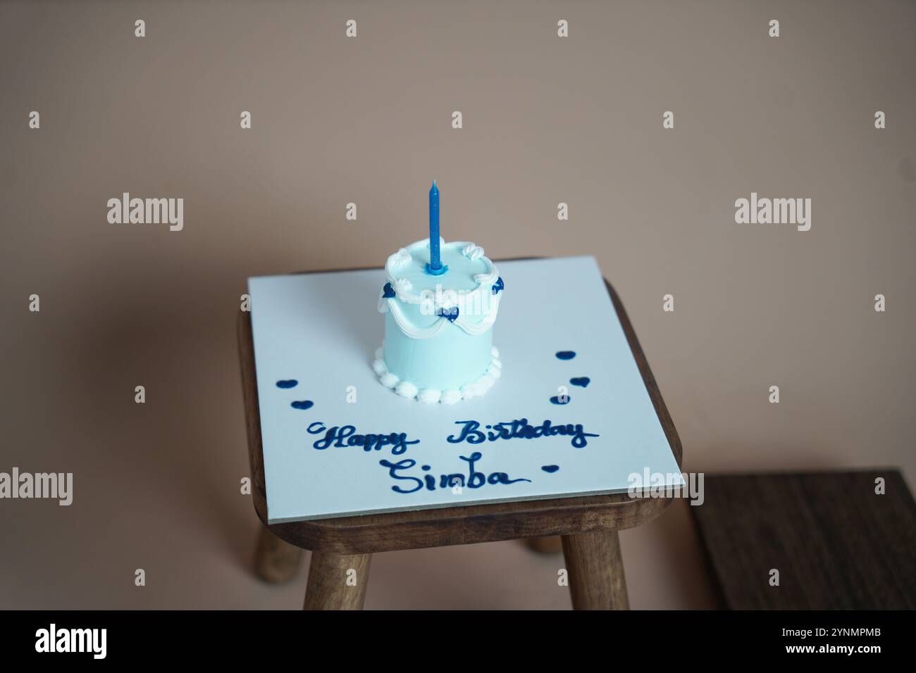 A charming mini birthday cake designed for Simba, adorned with delicate ...