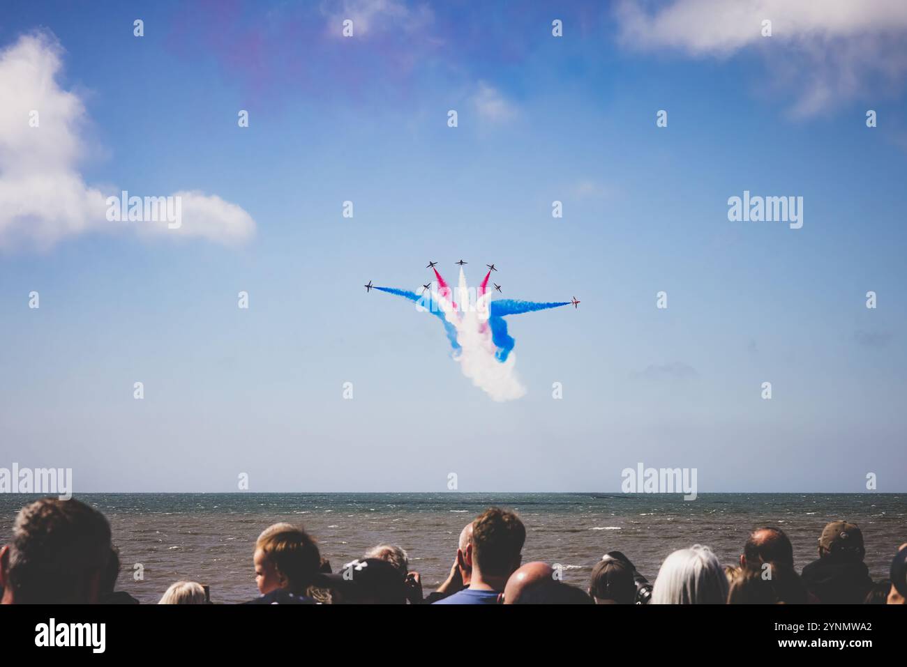 The Red Arrows perform an impressive fan formation above the sea ...