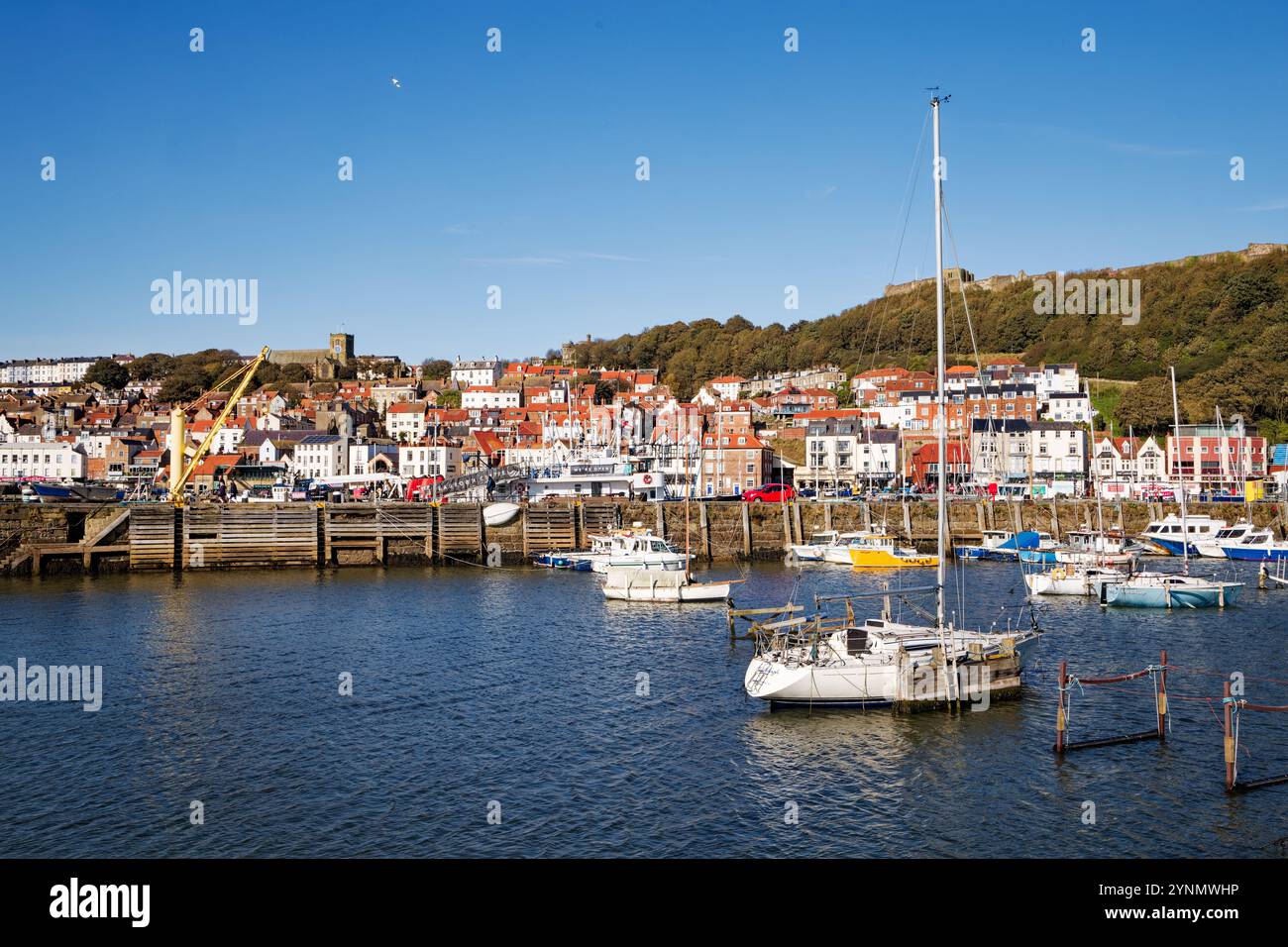 Boats moored in the harbour below Scarborough Castle, England Stock ...