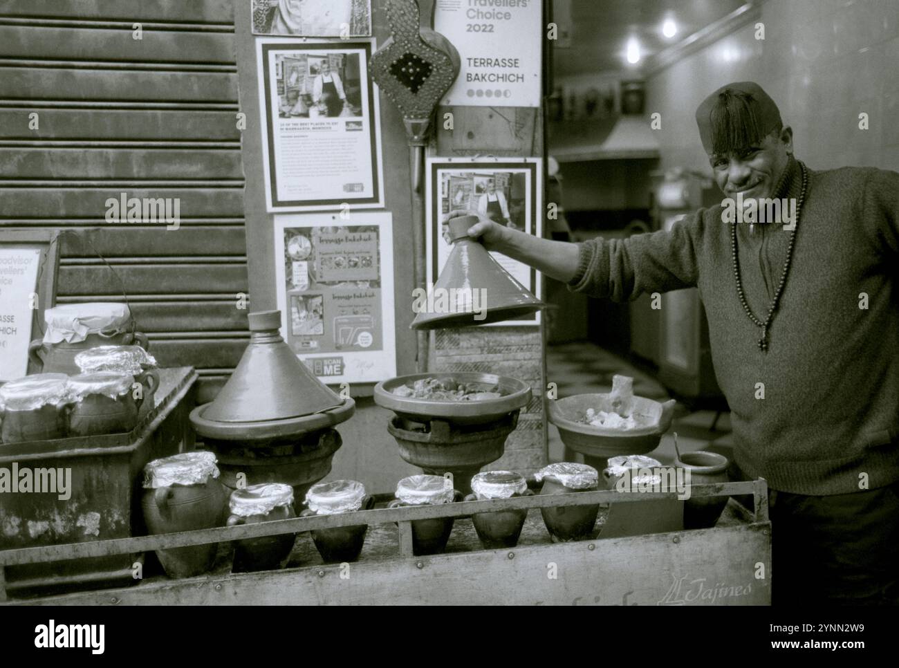 Chef and fez with his Tajine food in the casbah souk of the old city of ...