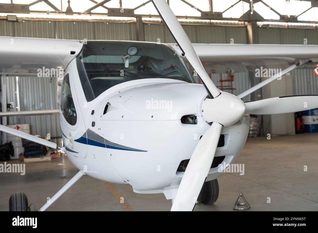 Small private lightweight propeller airplane in hangar, closeup photo ...