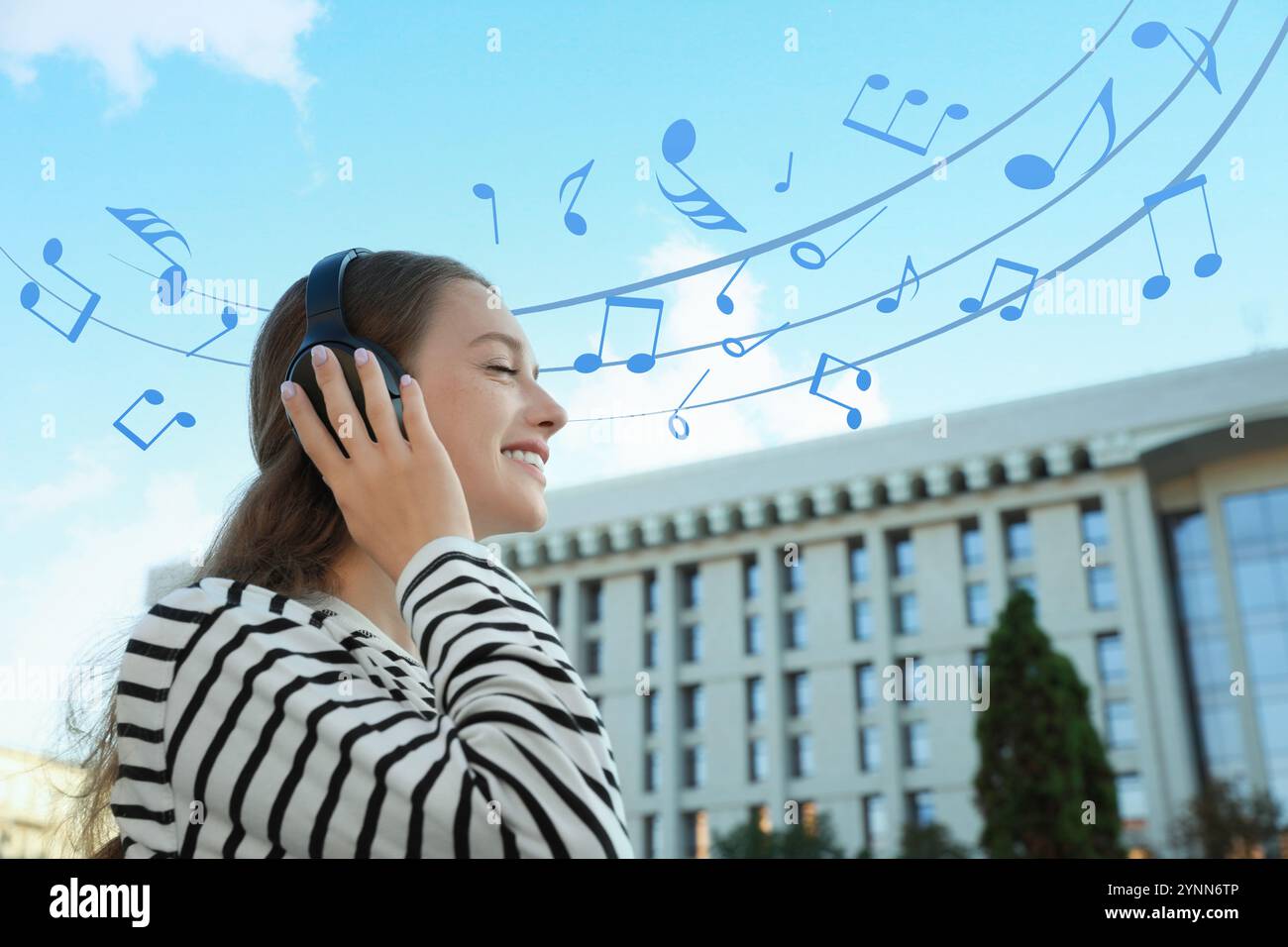 Happy woman with headphones on city street. Music notes flying near her ...
