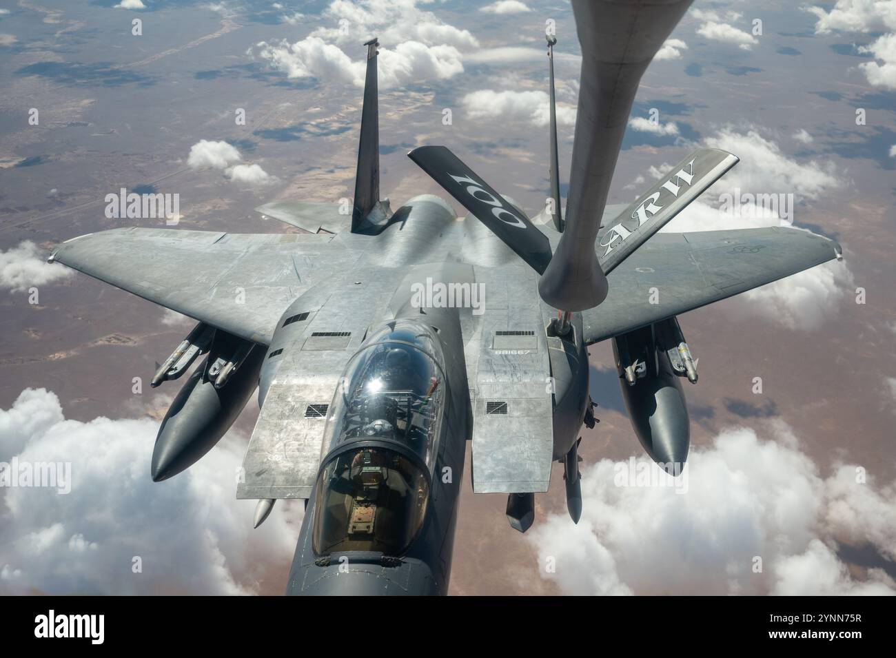 A U.S. Air Force F-15E Strike Eagle is refueled over the U.S. Central ...