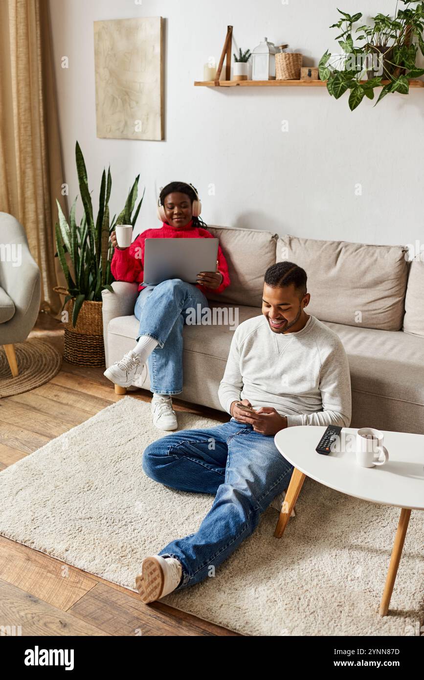 A couple enjoys cozy time together in their warm living room amid the ...