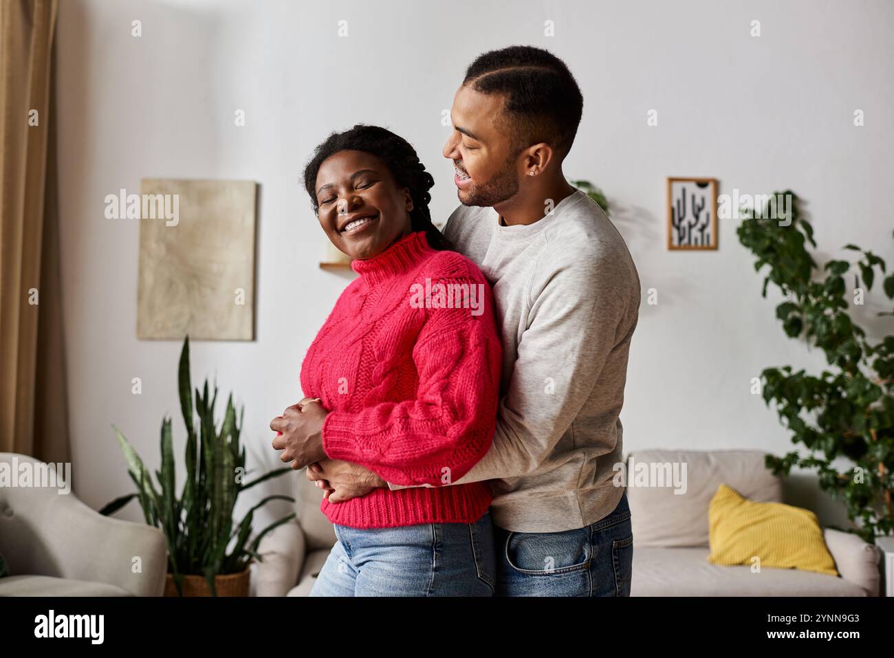 A joyful couple enjoys a loving moment, dressed in cozy sweaters at ...