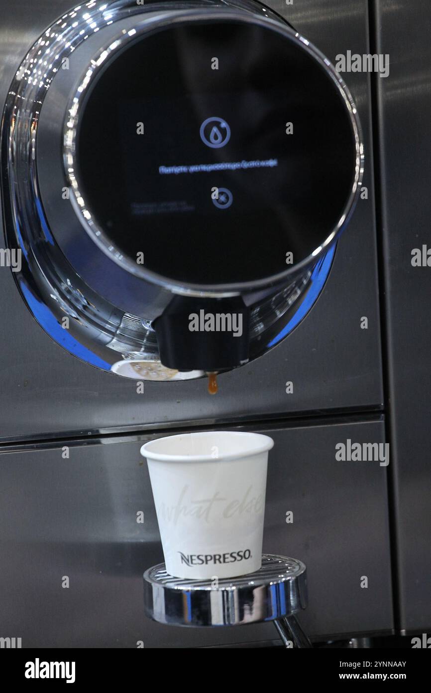 Fresh espresso dripping into a Nespresso-branded paper cup Stock Photo ...