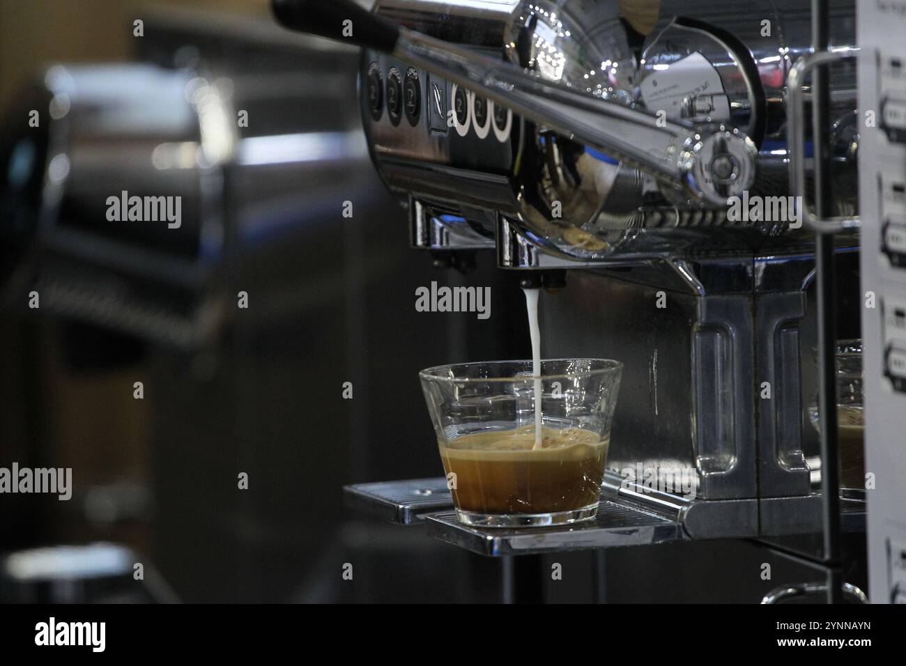 Fresh espresso dripping into a Nespresso-branded paper cup Stock Photo ...