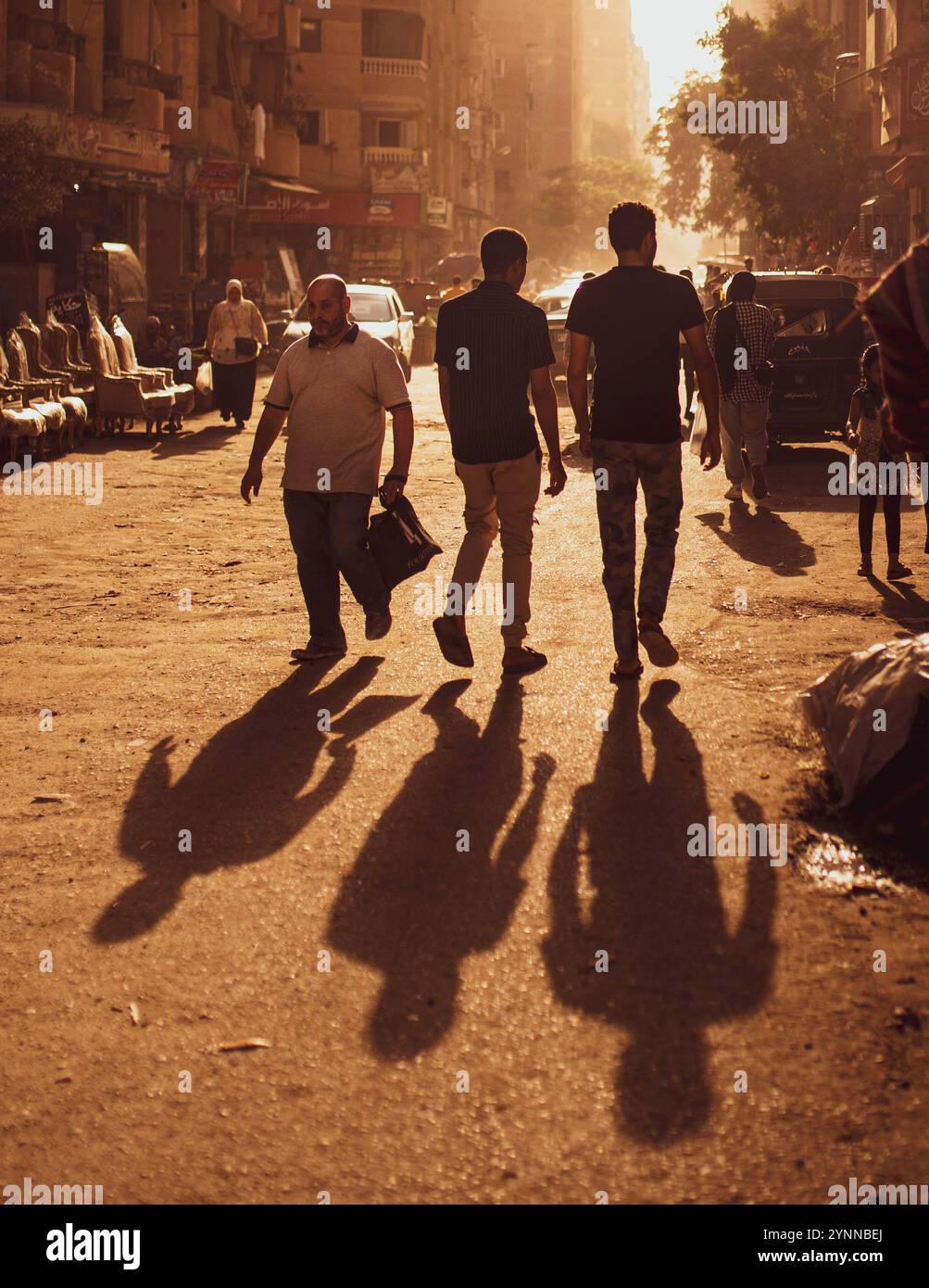 A group of people walking and their shadows align perfectly Stock Photo ...