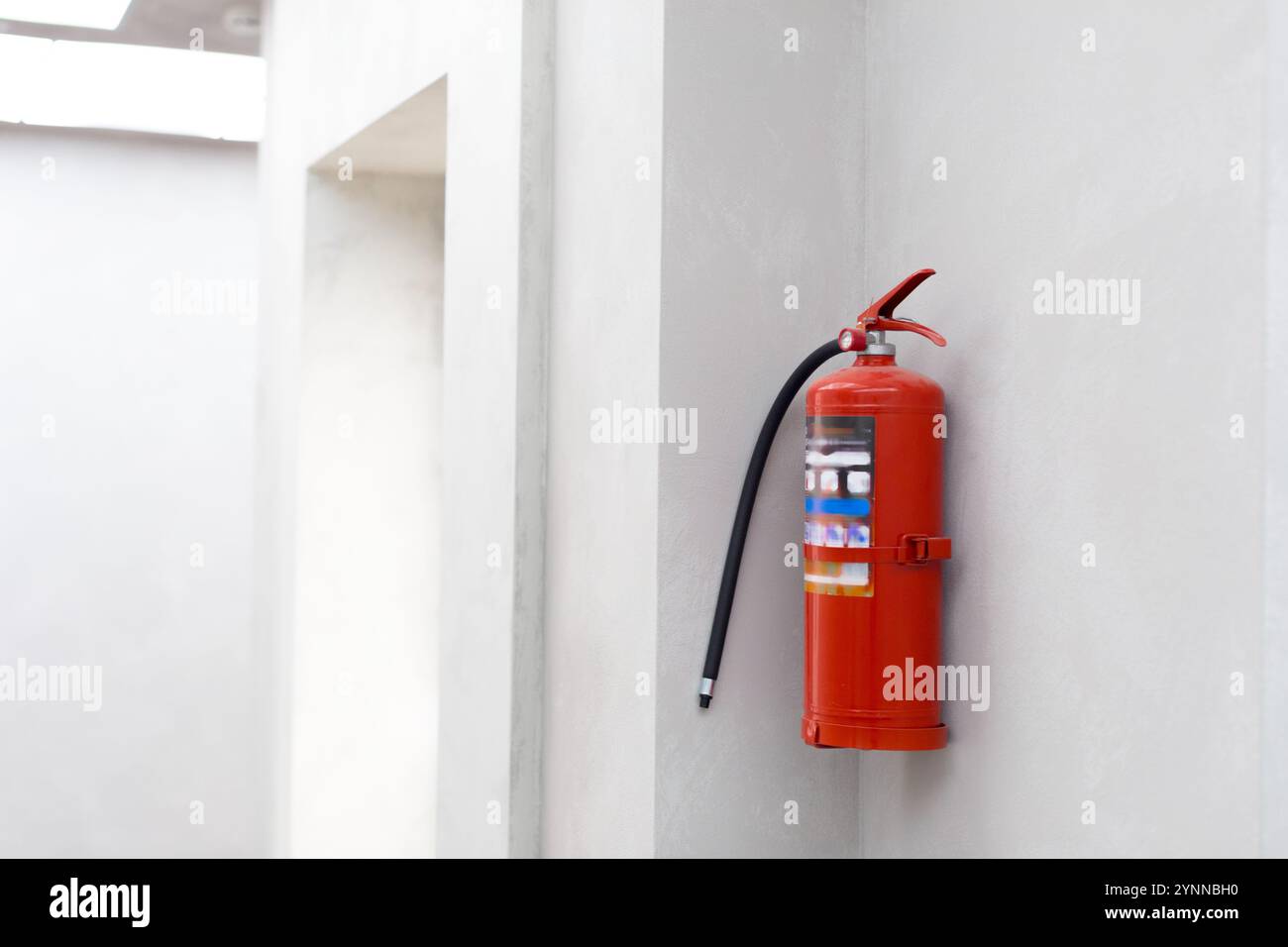 Fire extinguisher on the wall Stock Photo - Alamy