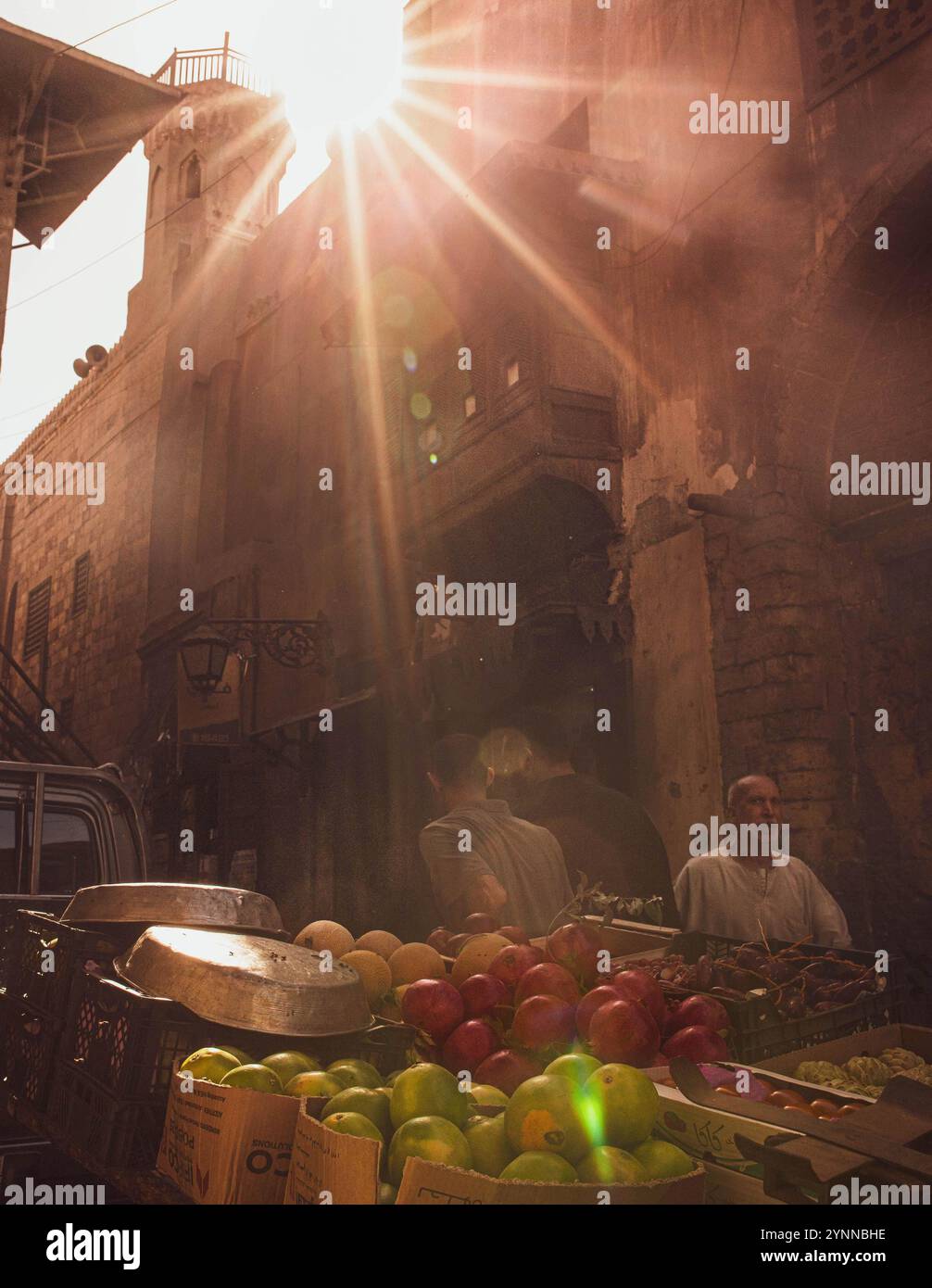 people walking in old Cairo Infront of a cart full of fruits Stock ...
