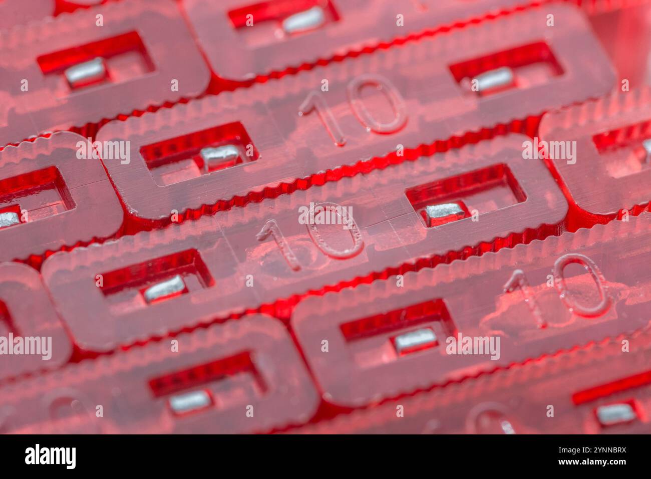 Neatly lined up mass of colourful automotive plug-in car fuses in their ...