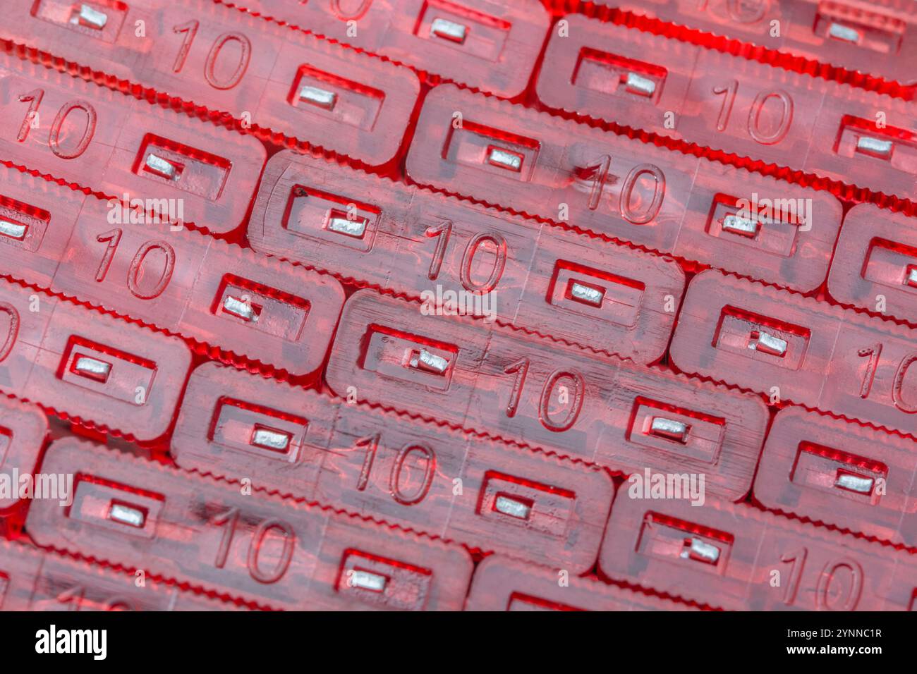 Neatly lined up mass of colourful automotive plug-in car fuses in their ...