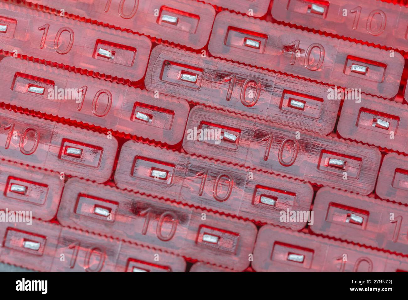 Neatly lined up mass of colourful automotive plug-in car fuses in their ...