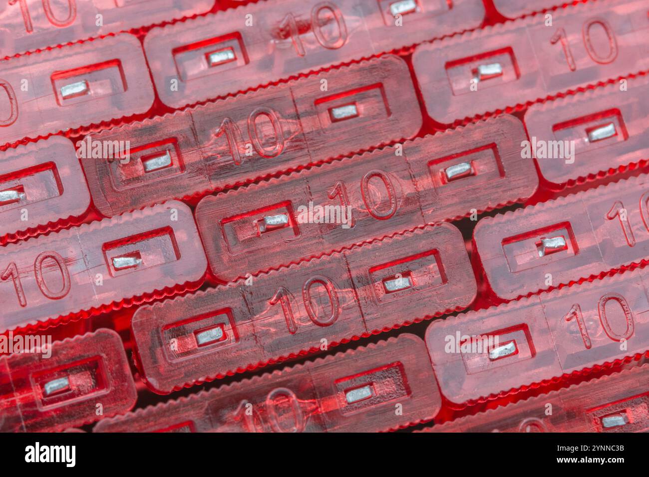 Neatly lined up mass of colourful automotive plug-in car fuses in their ...