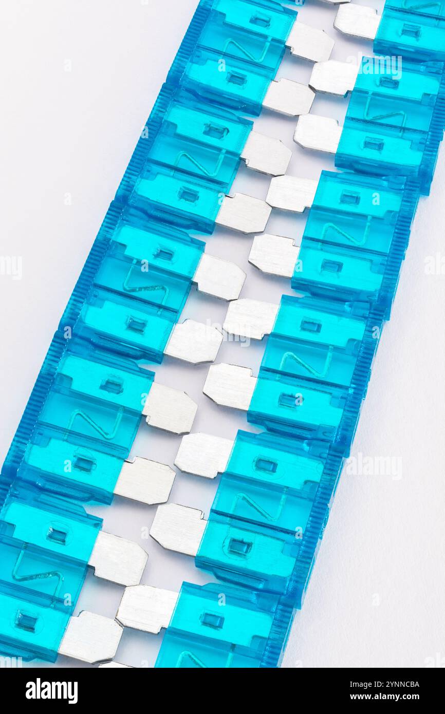 Neatly lined up mass of colourful automotive plug-in car fuses in their ...