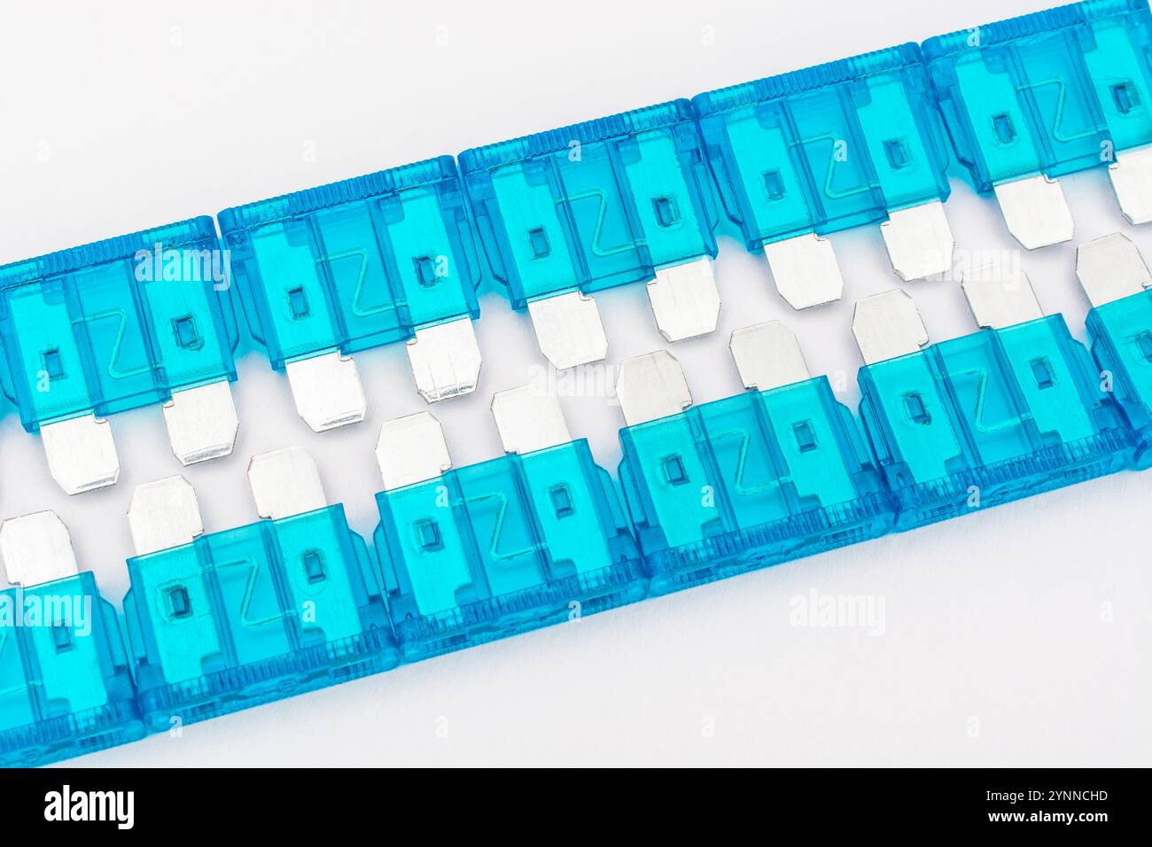 Neatly lined up mass of colourful automotive plug-in car fuses in their ...