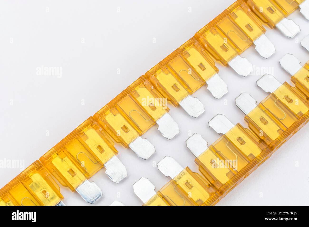 Neatly lined up mass of colourful automotive plug-in car fuses in their ...