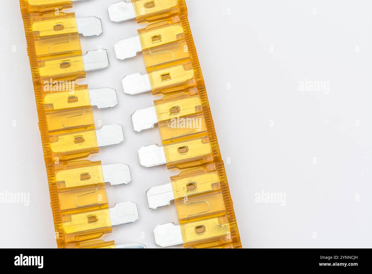 Neatly lined up mass of colourful automotive plug-in car fuses in their ...