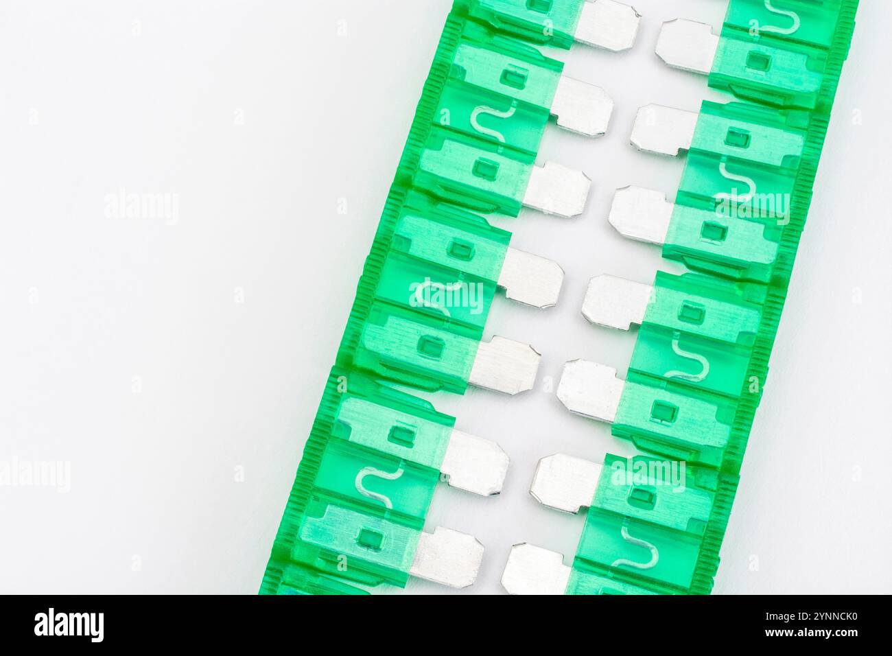 Neatly lined up mass of colourful automotive plug-in car fuses in their ...