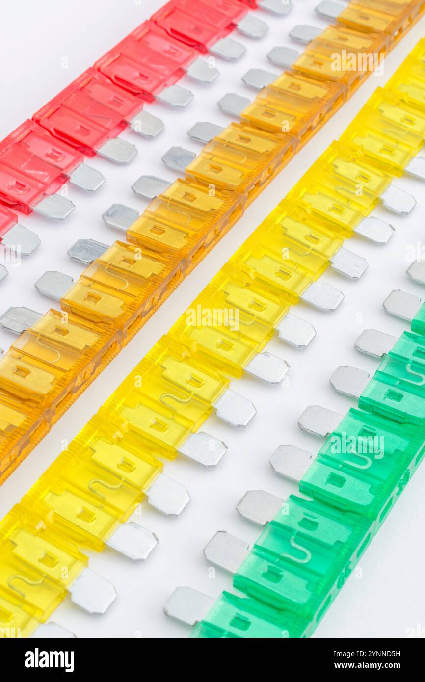 Neatly aligned mass of colourful automotive plug-in car fuses in their ...
