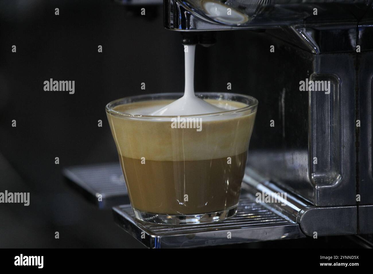 Fresh espresso dripping into a Nespresso-branded paper cup Stock Photo ...