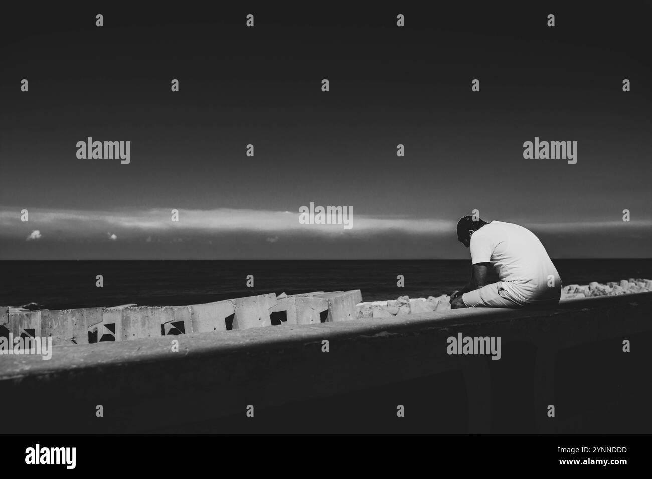 Lonely man sitting Black and White Stock Photos & Images - Alamy