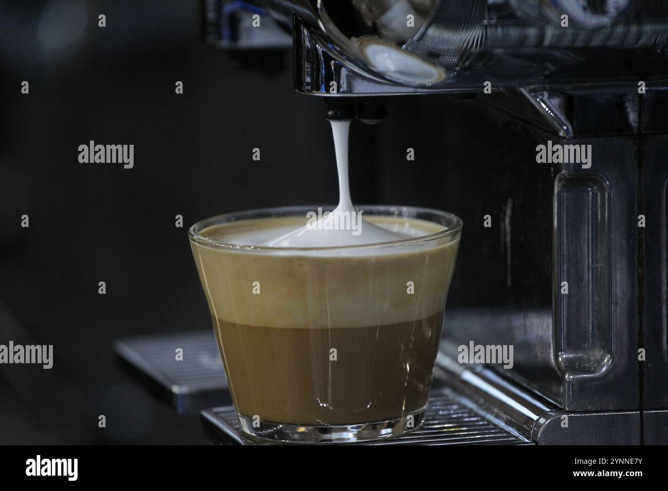 Fresh espresso dripping into a Nespresso-branded paper cup Stock Photo ...