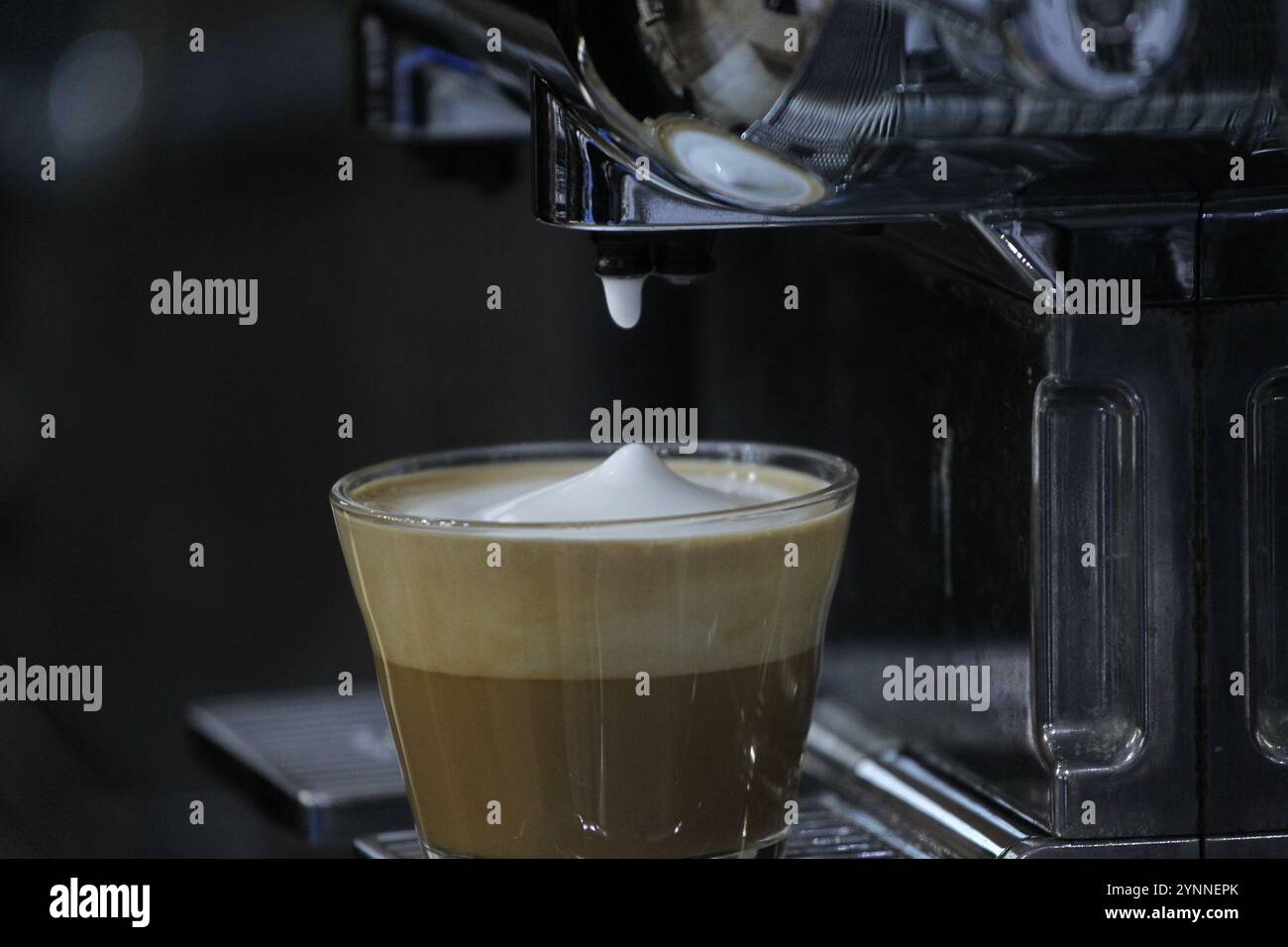 Fresh espresso dripping into a Nespresso-branded paper cup Stock Photo ...