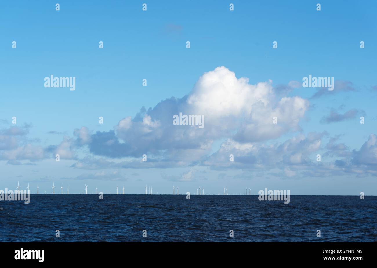 White cloud and blue sky over the Gwynt y Môr offshore wind farm on the ...