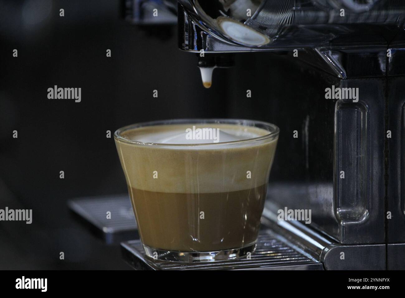 Fresh espresso dripping into a Nespresso-branded paper cup Stock Photo ...