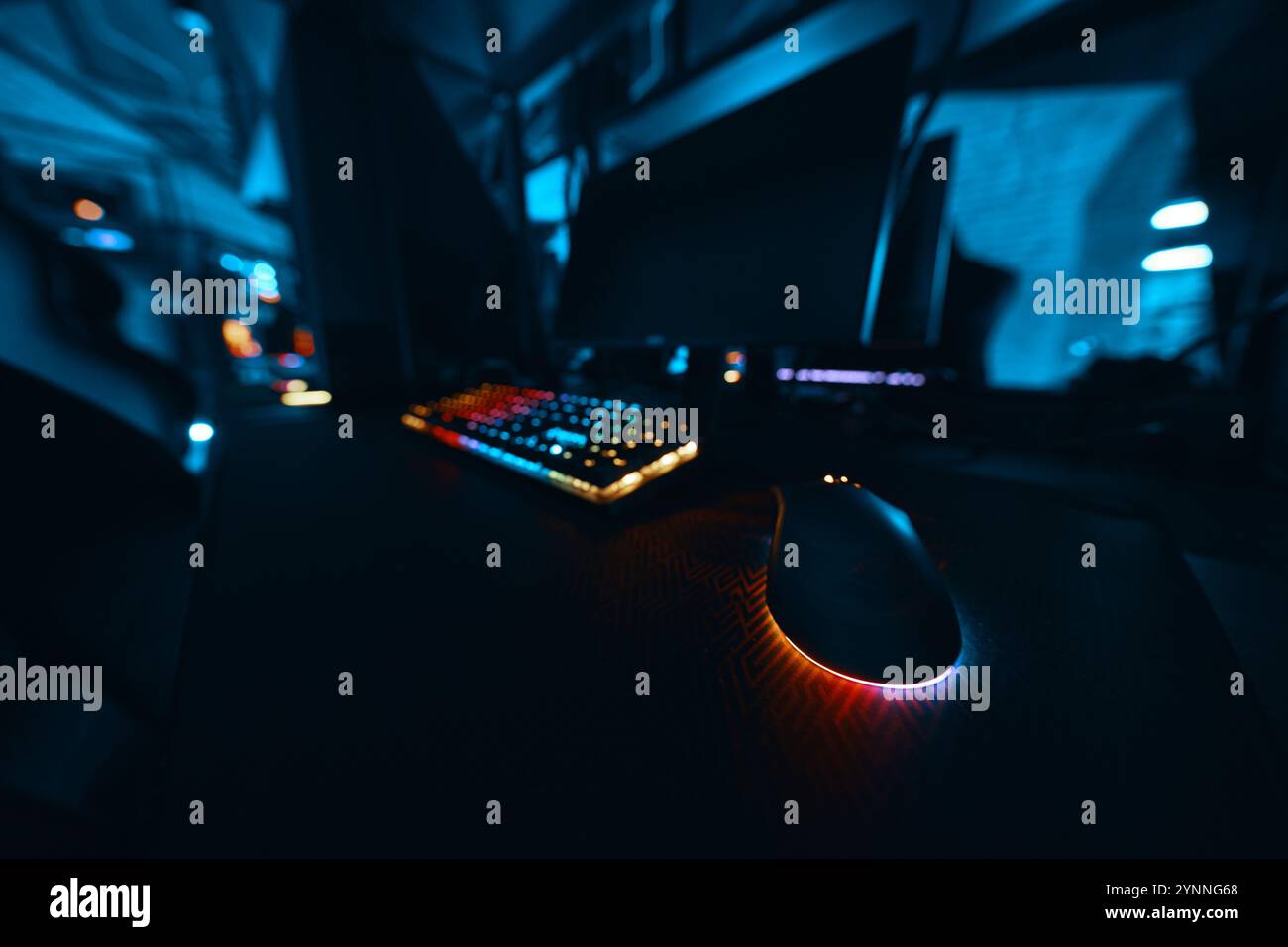 Gaming workspace with illuminated keyboard and mouse in a dark ...