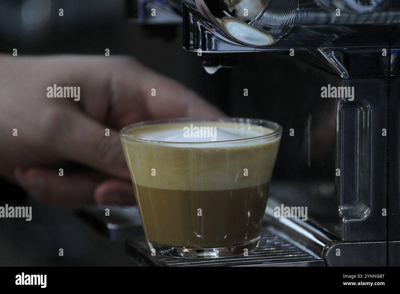 Fresh espresso dripping into a Nespresso-branded paper cup Stock Photo ...