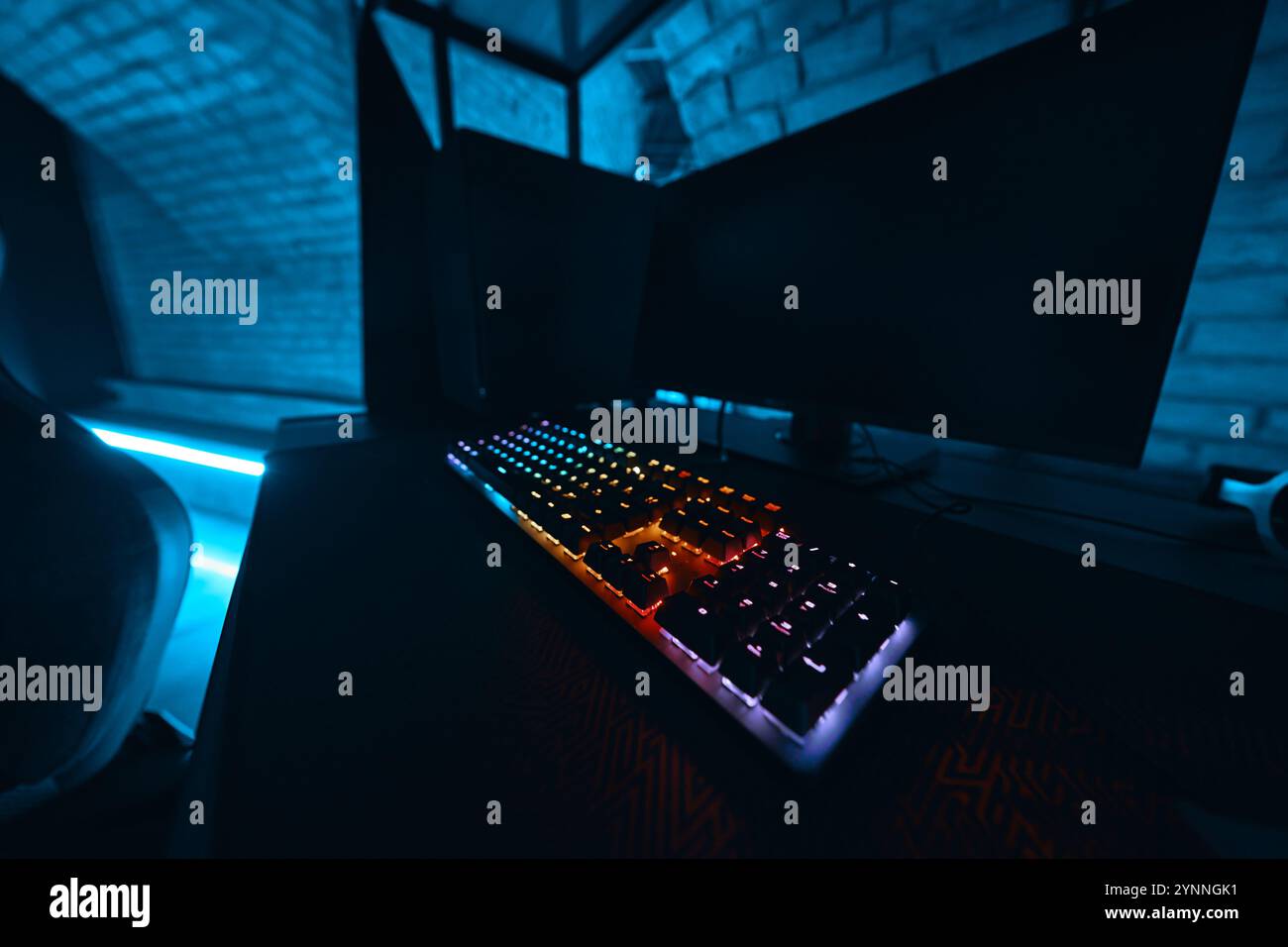 Gaming setup with colorful keyboard in a modern workspace at night ...