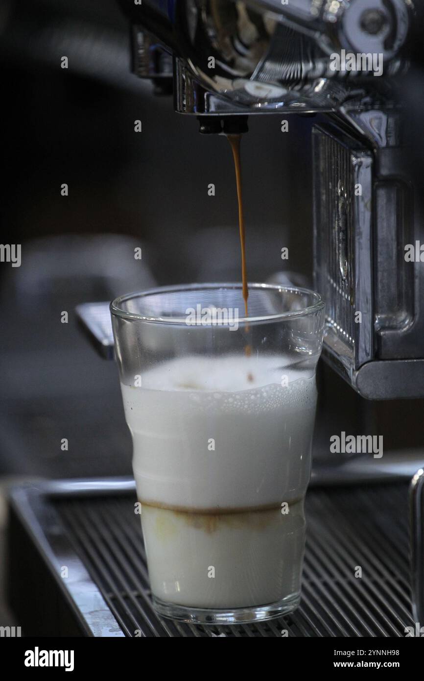 Fresh espresso dripping into a Nespresso-branded paper cup Stock Photo ...