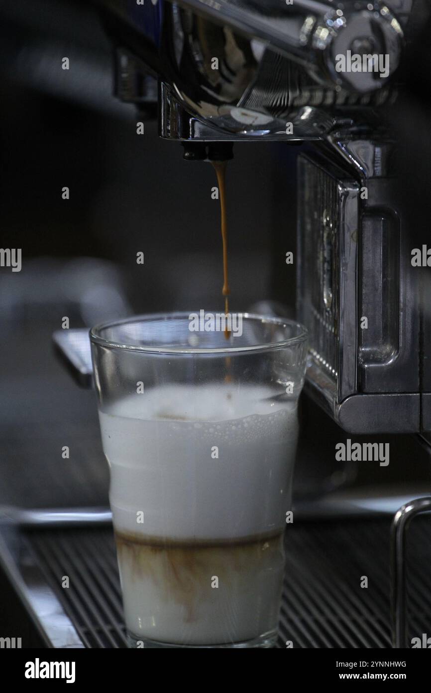 Fresh espresso dripping into a Nespresso-branded paper cup Stock Photo ...