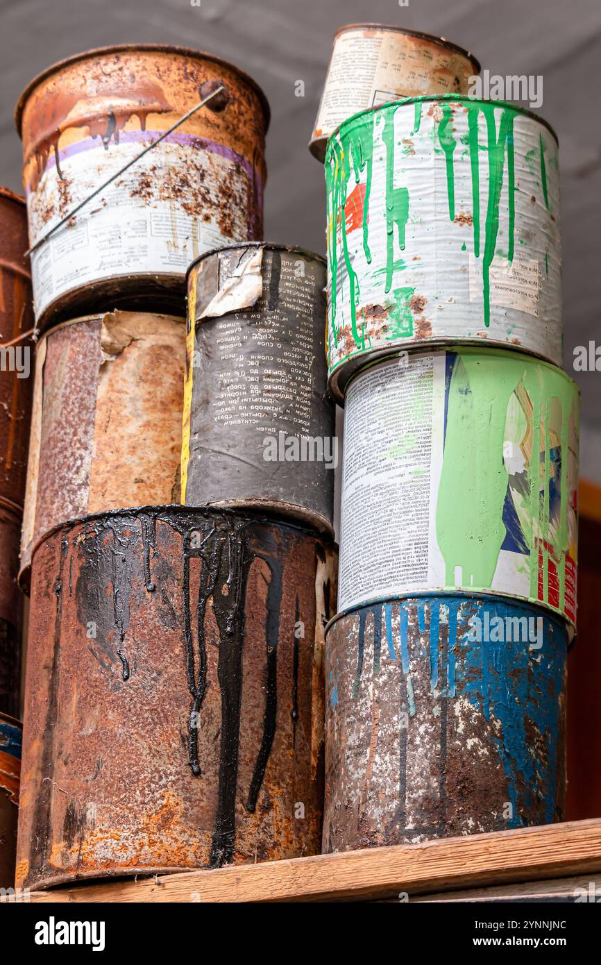 A collection of paint cans, buckets, toxic and hazardous material ...