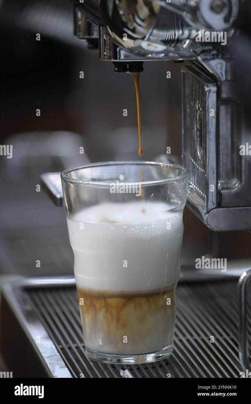 Fresh espresso dripping into a Nespresso-branded paper cup Stock Photo ...