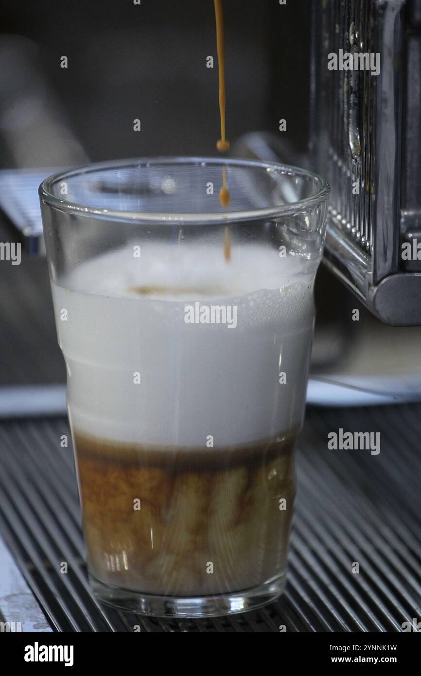 Fresh espresso dripping into a Nespresso-branded paper cup Stock Photo ...