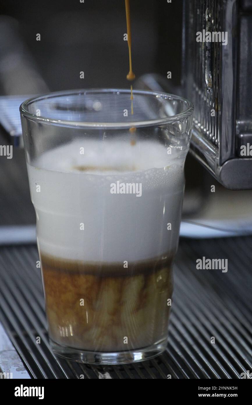 Fresh espresso dripping into a Nespresso-branded paper cup Stock Photo ...
