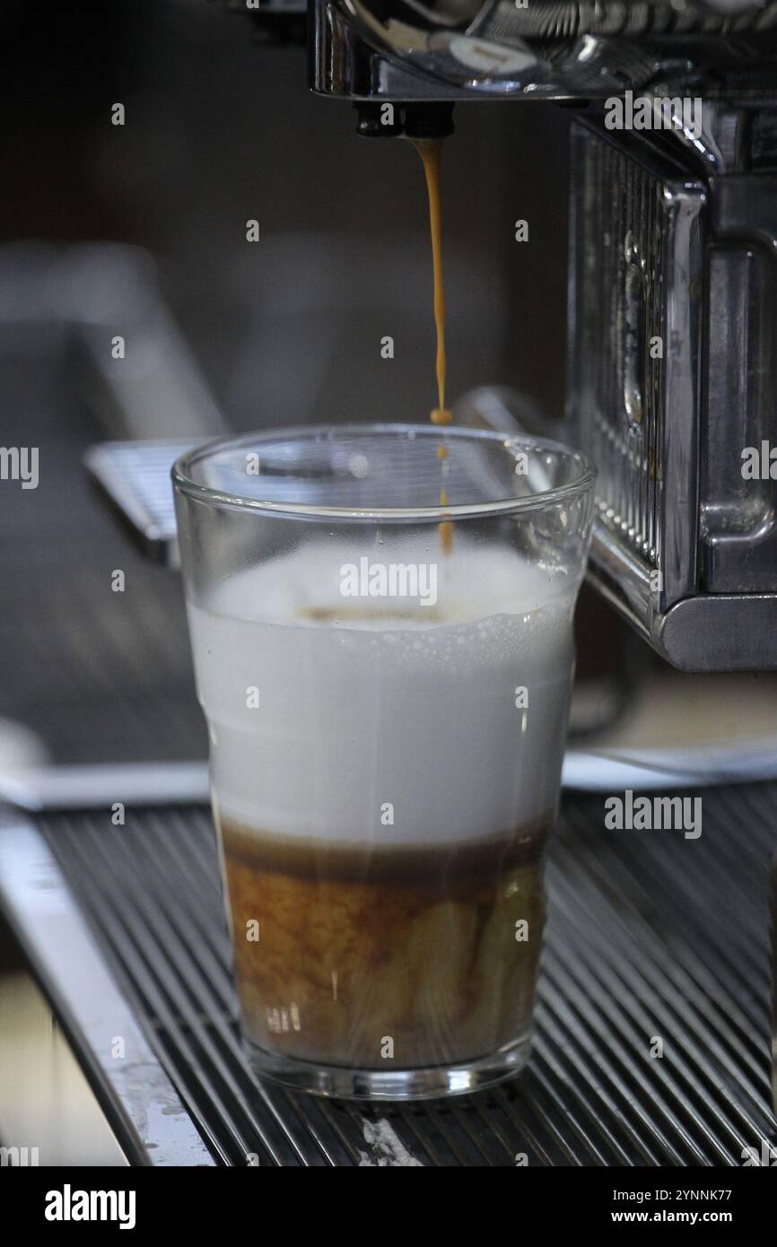 Fresh espresso dripping into a Nespresso-branded paper cup Stock Photo ...
