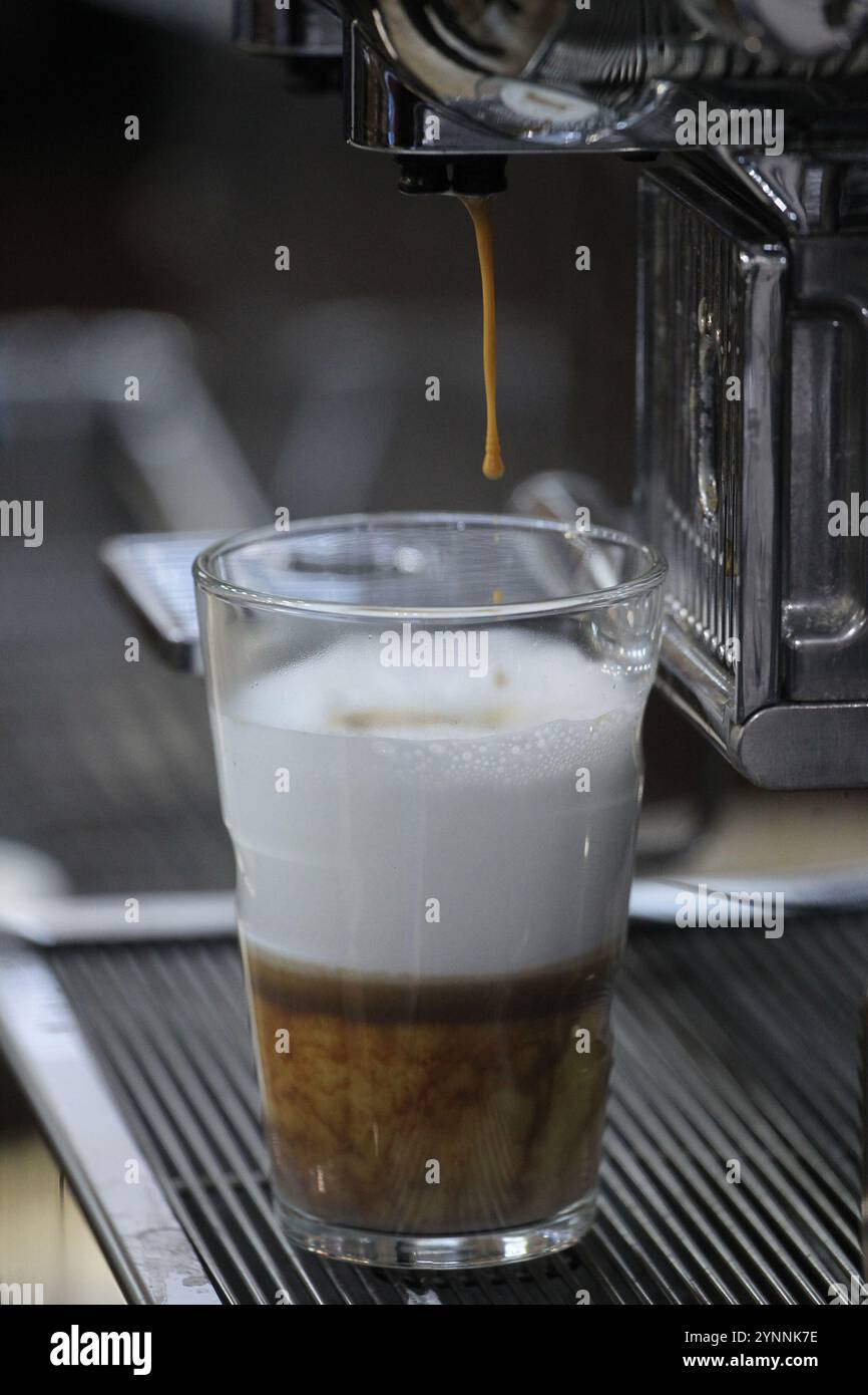 Fresh espresso dripping into a Nespresso-branded paper cup Stock Photo ...