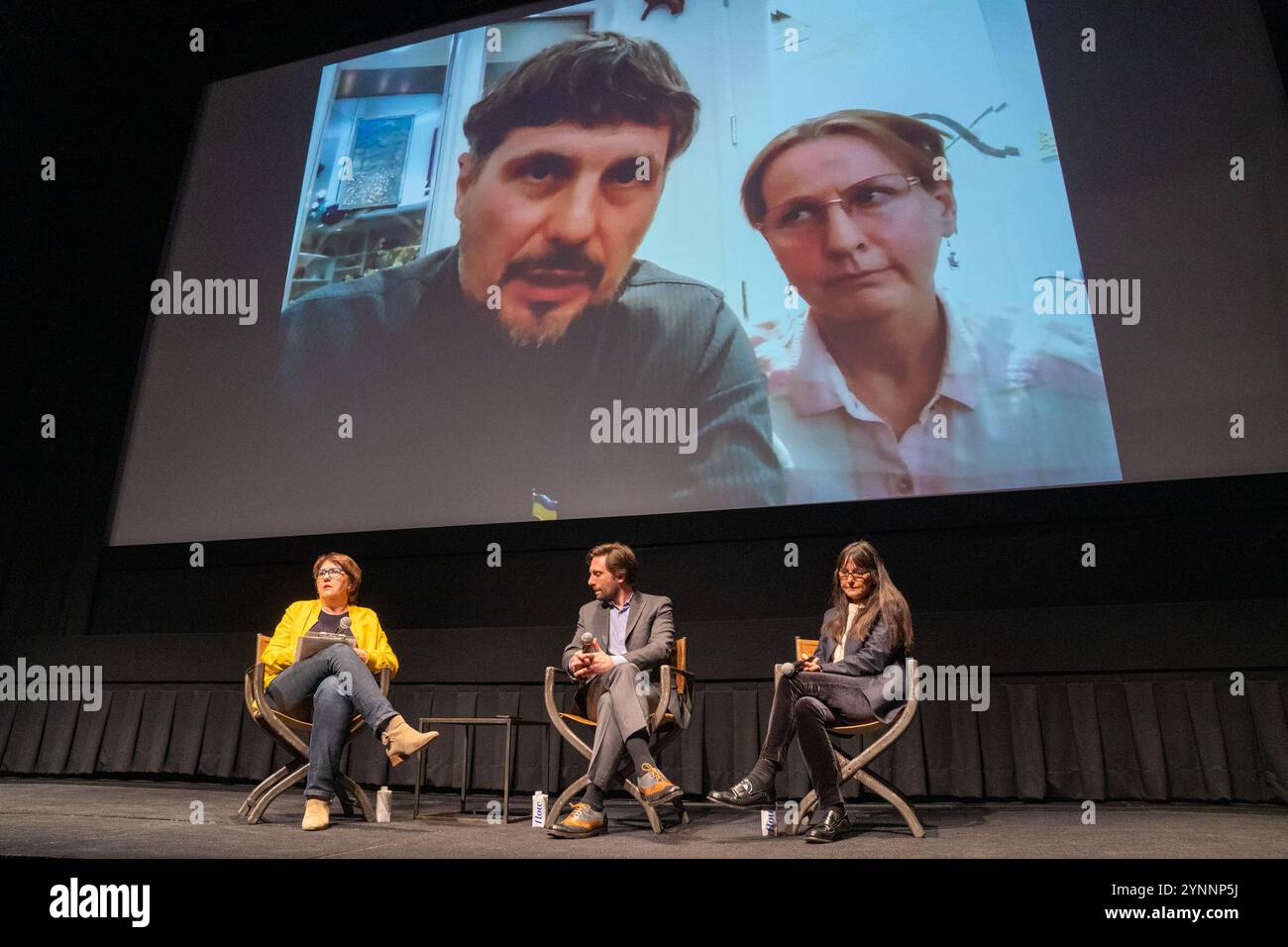 On Screen, Via Zoom (L to R) Slava Leontyev and Anya Stasenko. On Stage ...