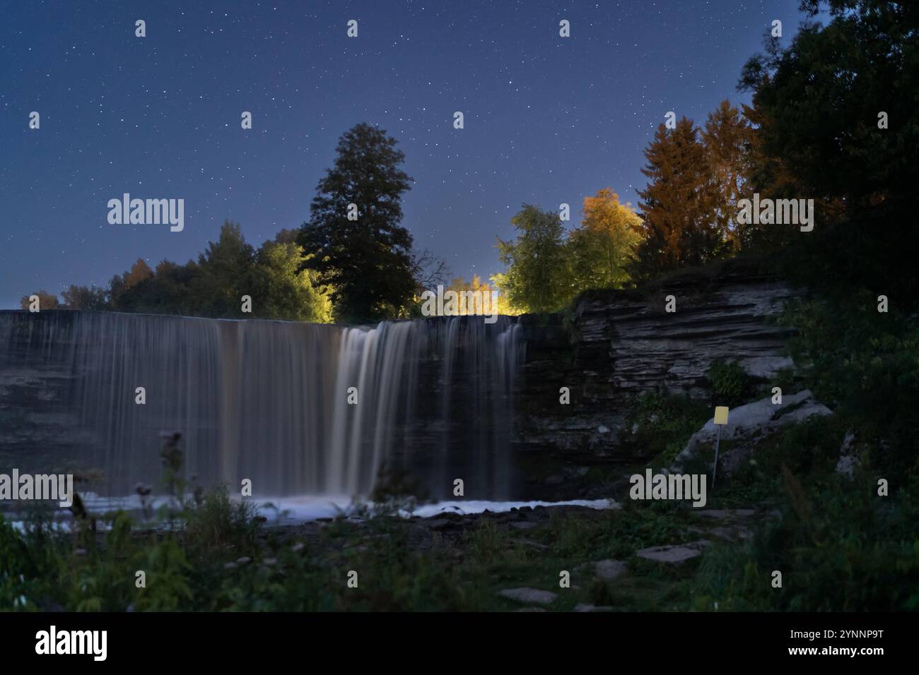 Estonian nature. Jagala waterfall at night under the starry sky in ...
