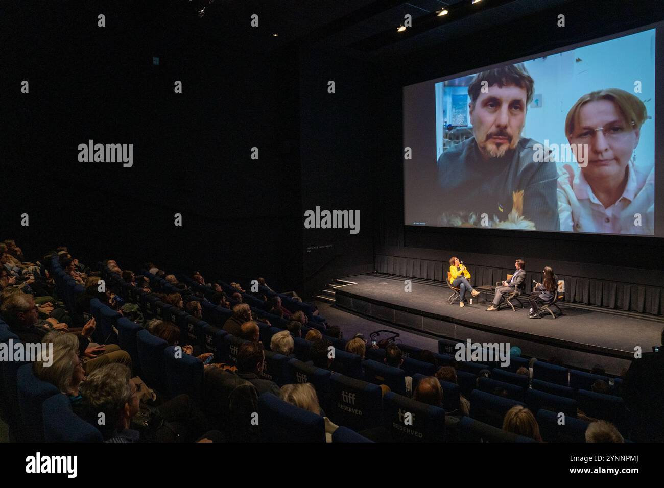 On Screen, Via Zoom (L to R) Slava Leontyev and Anya Stasenko. On Stage ...