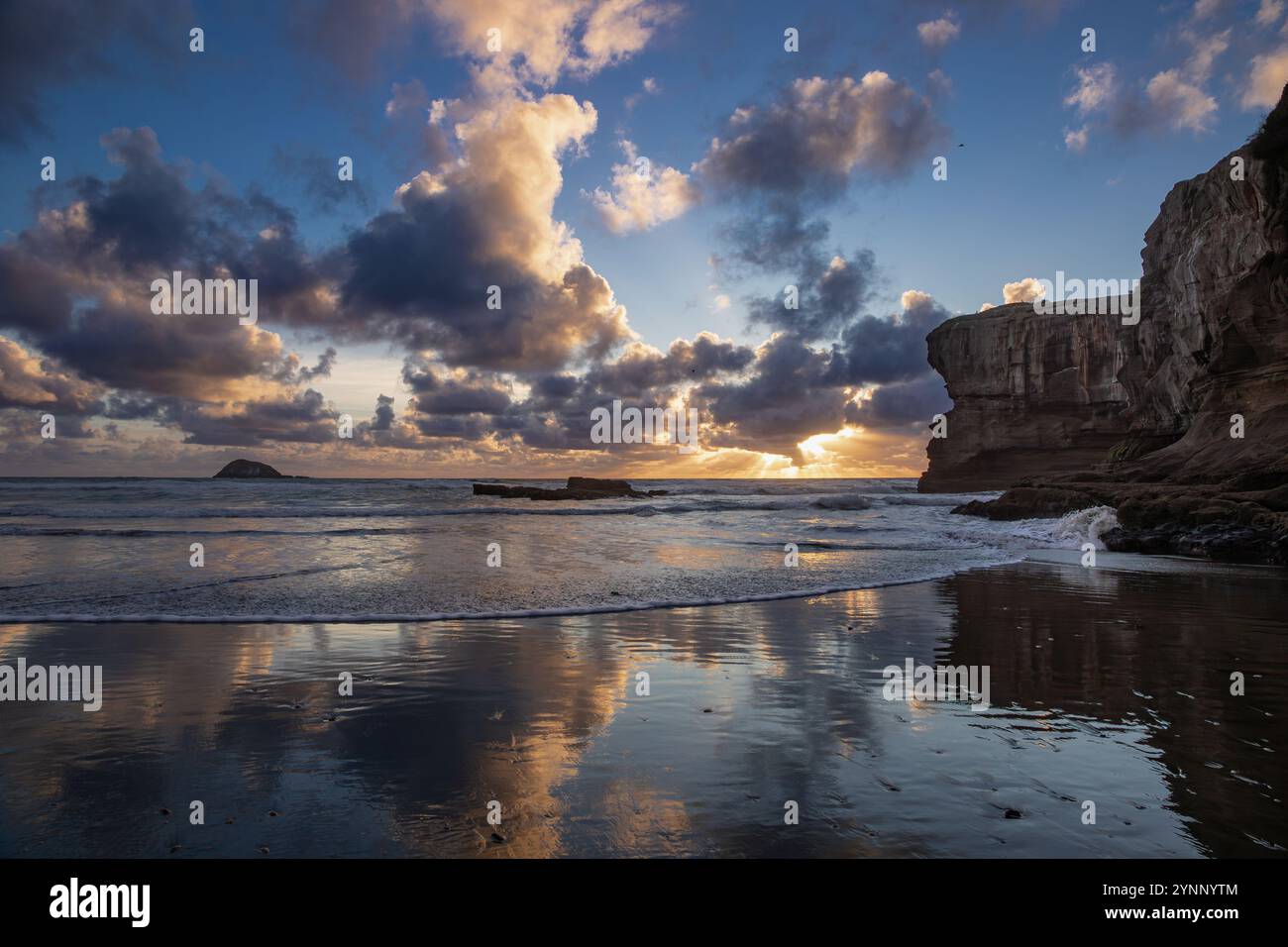 Ethereal moment of Muriwai Beach covered with clouds at sunset Stock ...