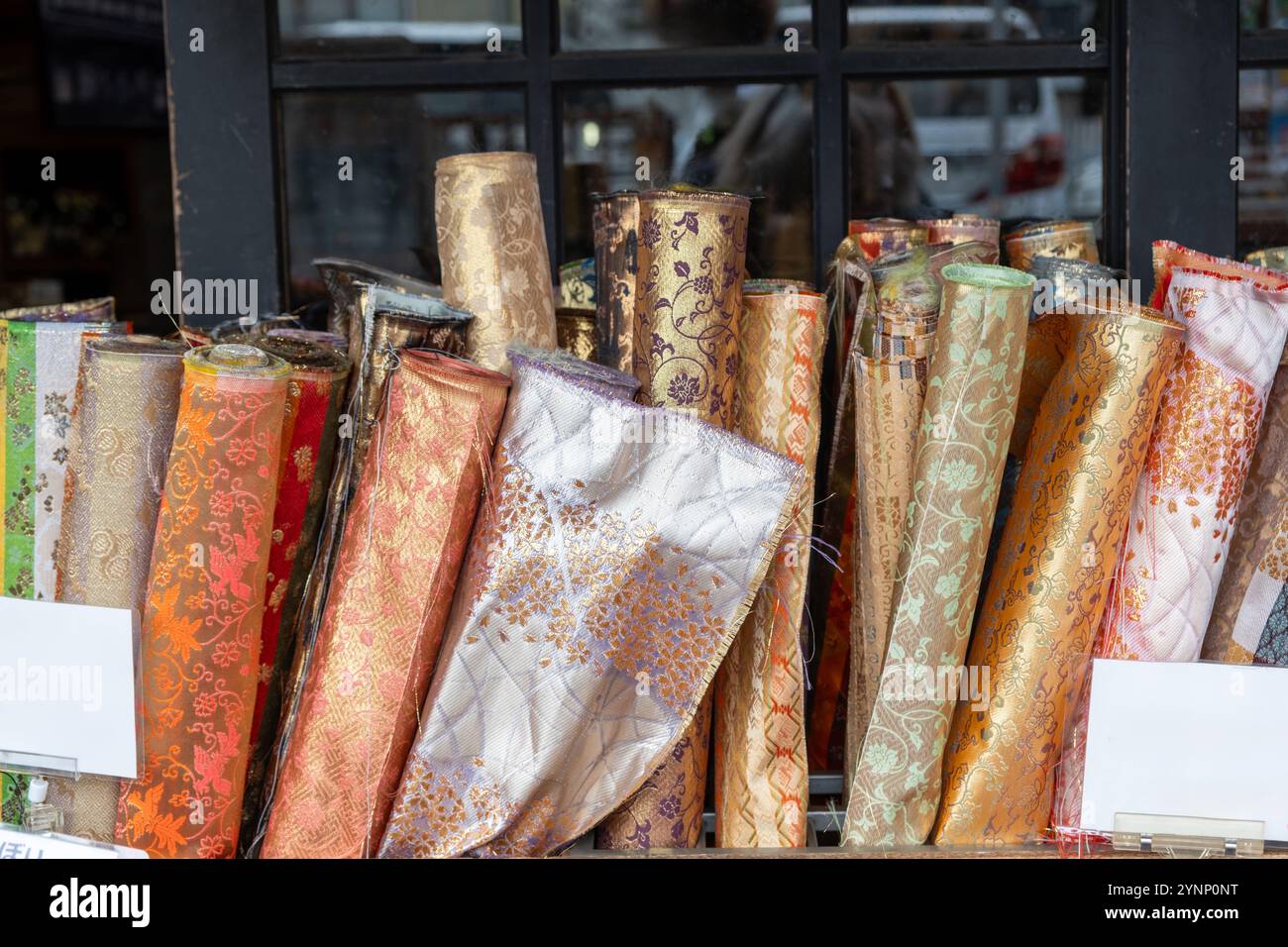 Japanese textiles collection at a shop display, Rolls of fabric with ...