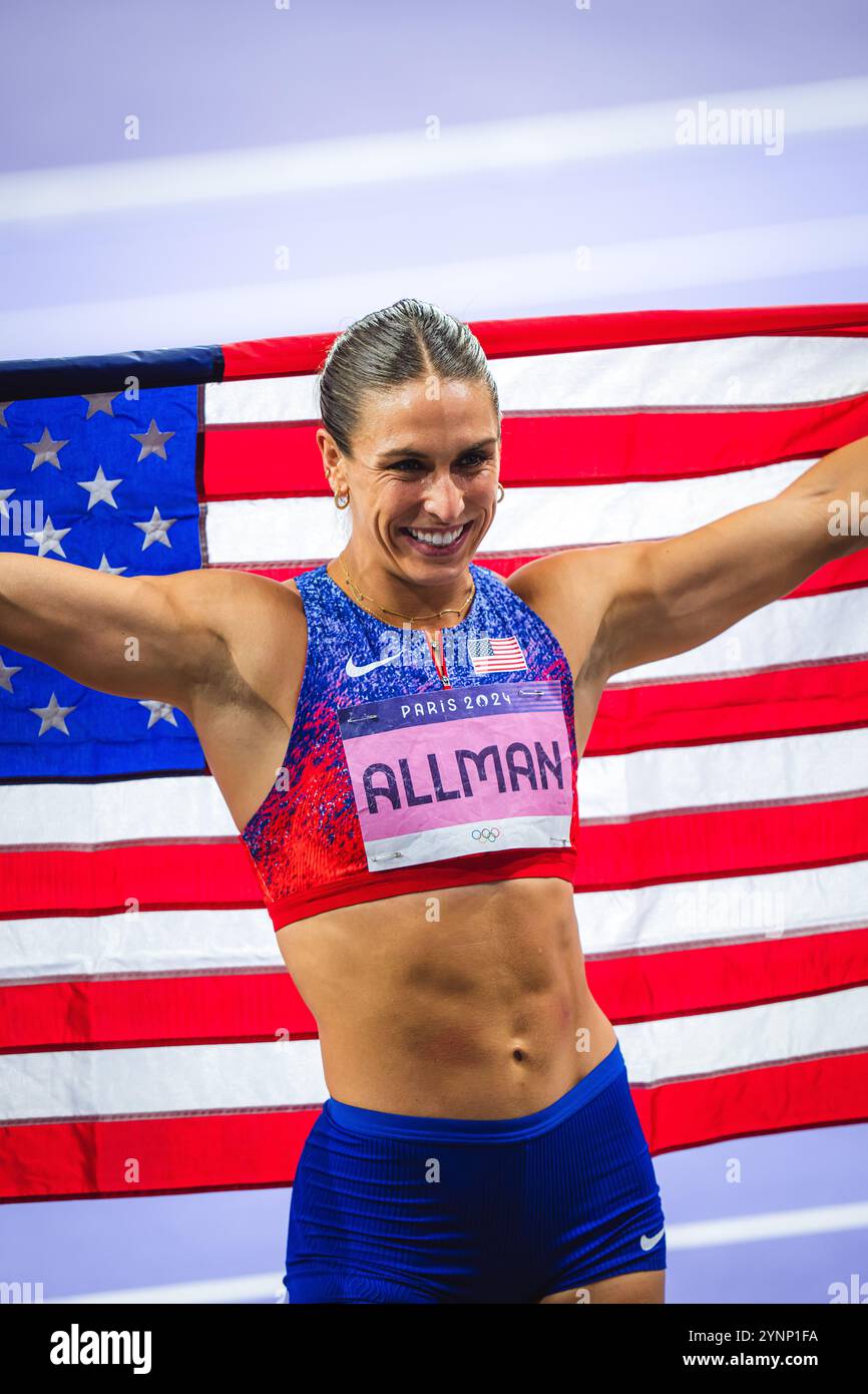 Valarie Allman celebrating with her country's flag in the at the Paris ...