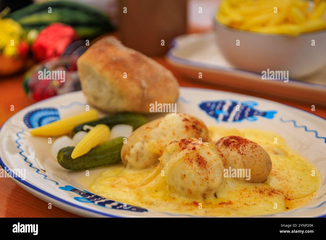 Melted raclette cheese with potatoes, pickles and bread, Swiss ...